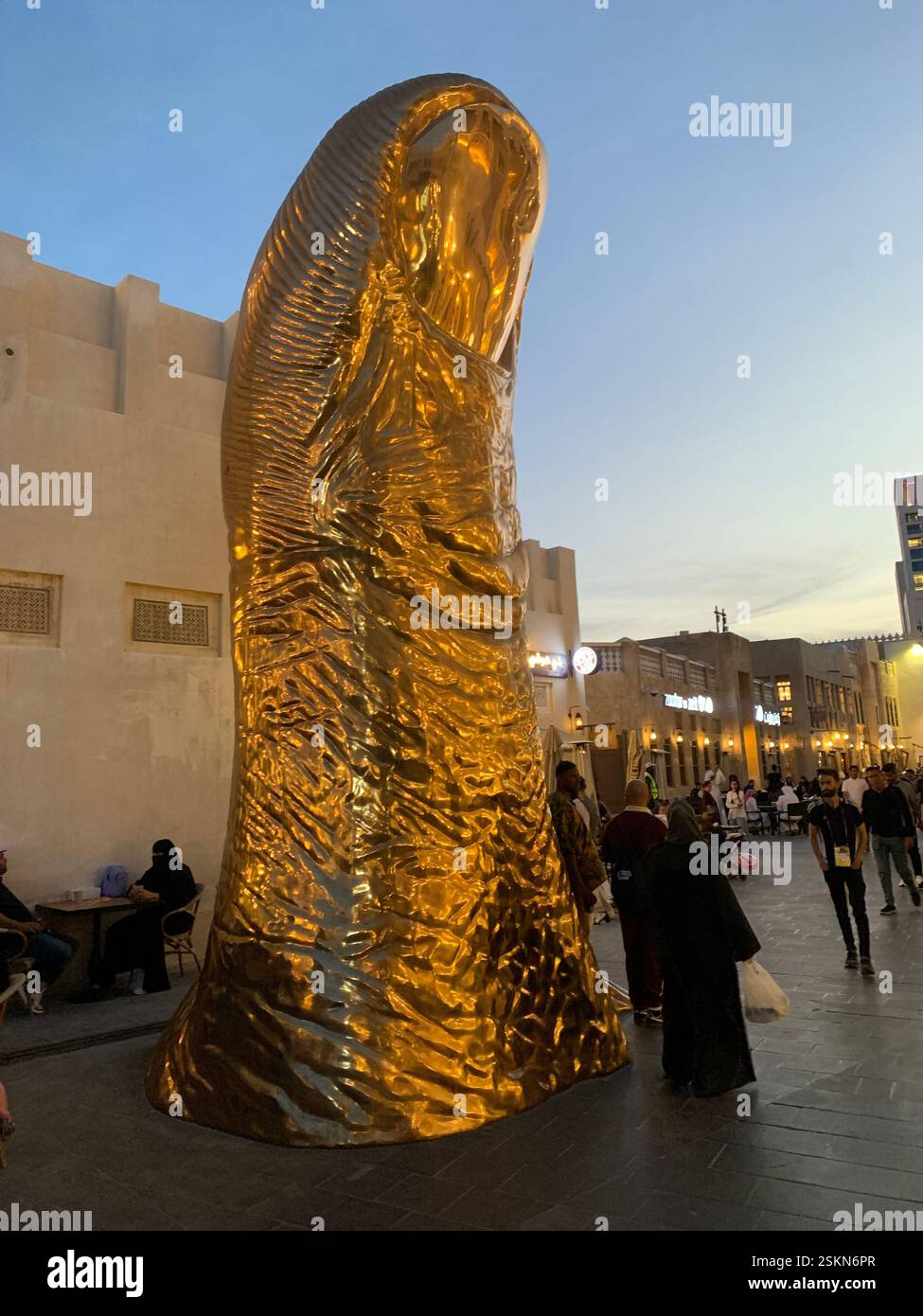 Large Golden Thumb Sculpture at night Souq Waqif Stock Photo - Alamy