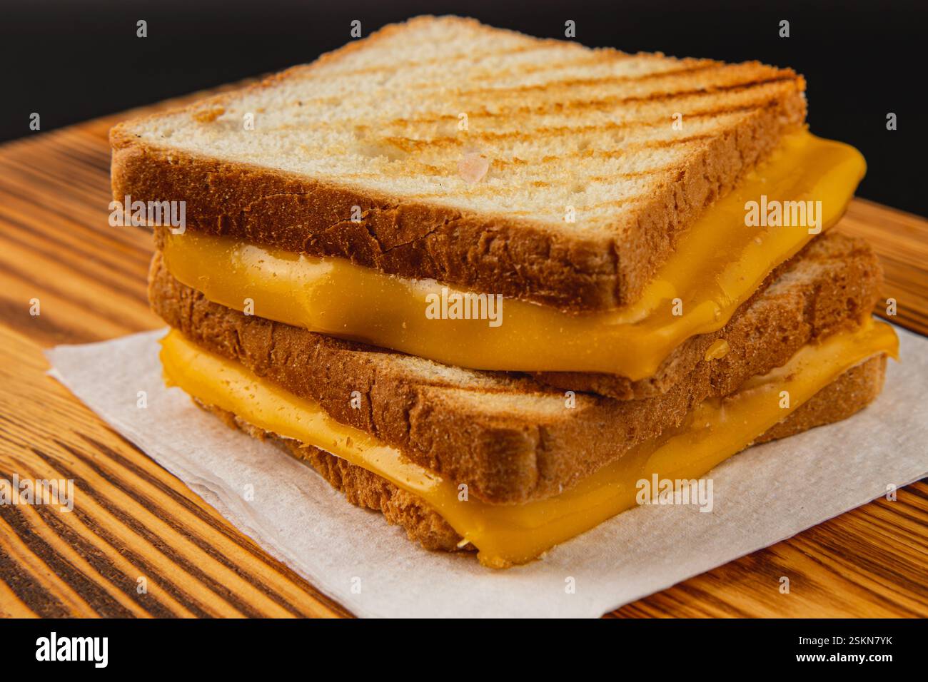 A warm grilled cheese sandwich with melted cheese layered between ...