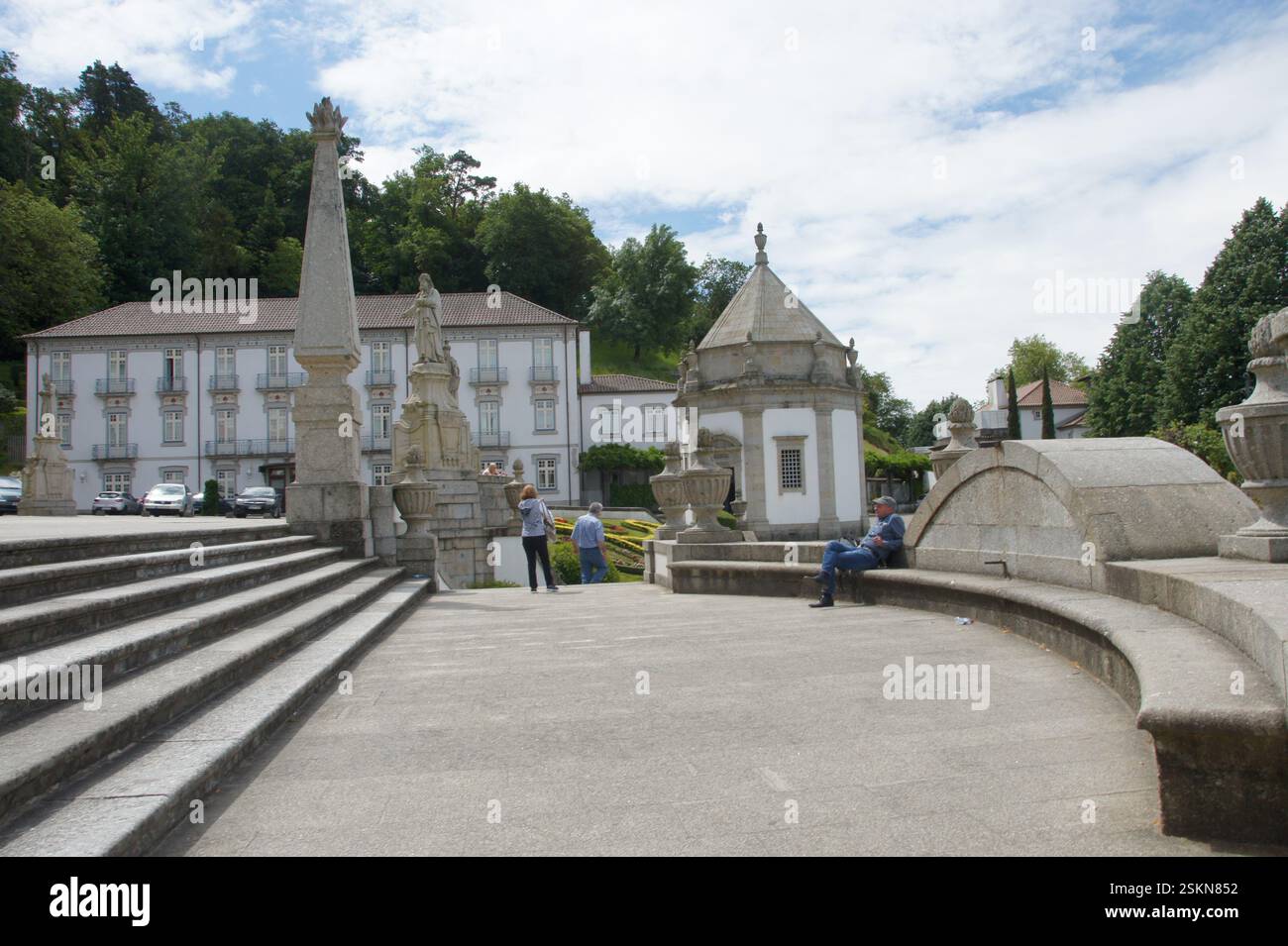 Stone stairs wind up to a curved walkway, leading to a grand plaza in ...