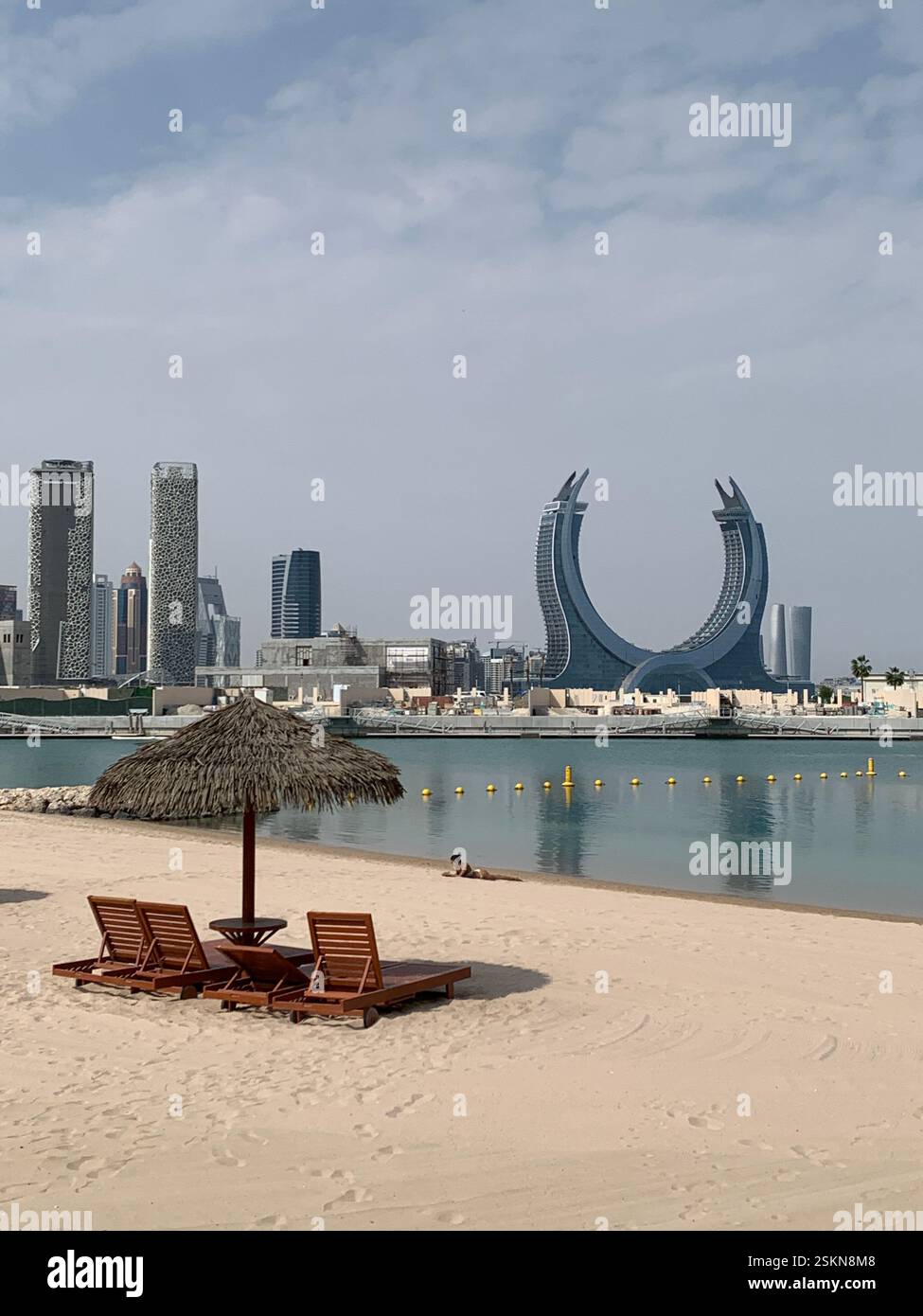 Sun lounger and umbrella at private beach in Qanat Quartier Doha Qatar ...