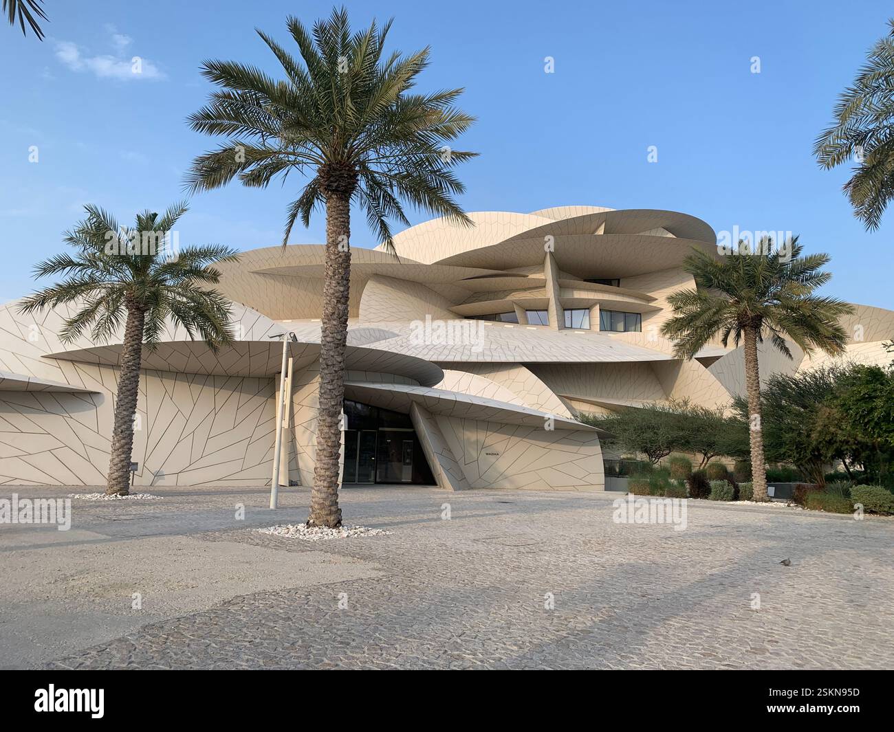 National Museum of Qatar with palm trees Stock Photo - Alamy