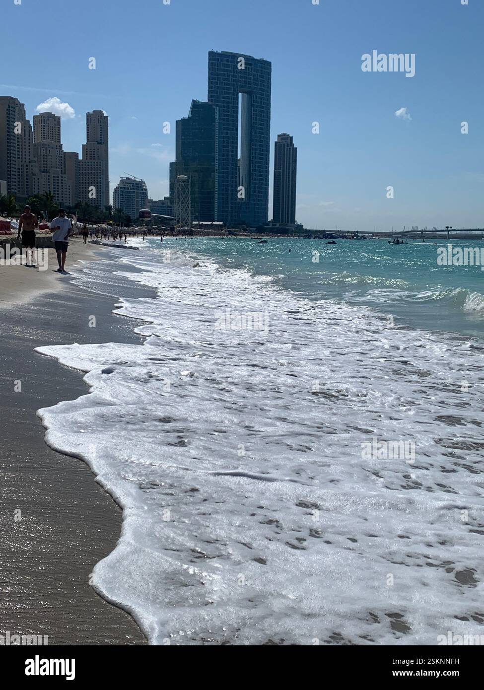 Frothy water at Dubai Marina beach with view of Jumeirah Gate Stock ...