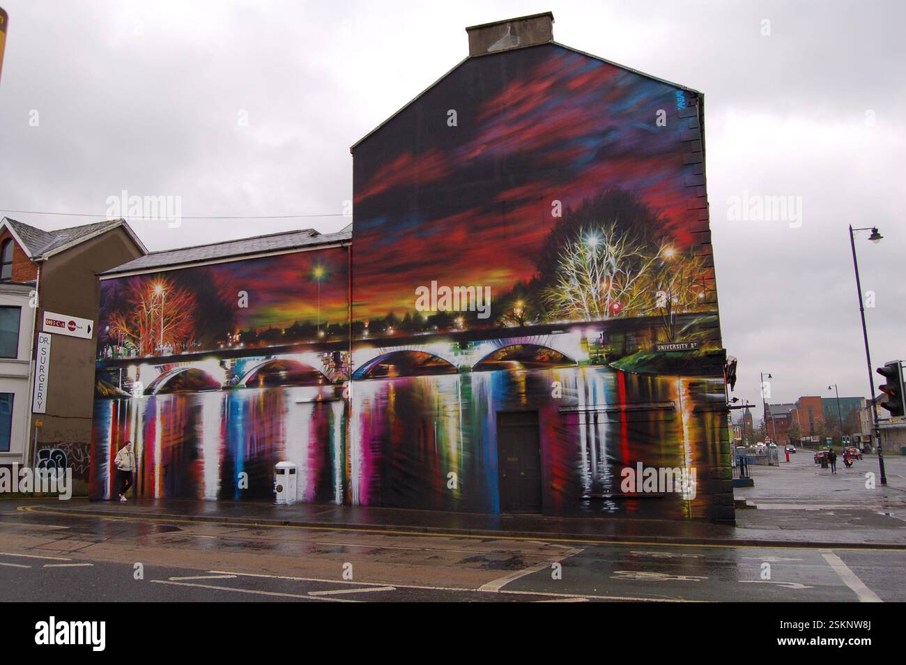 A vibrant mural of a bridge with colourful reflections on a building ...