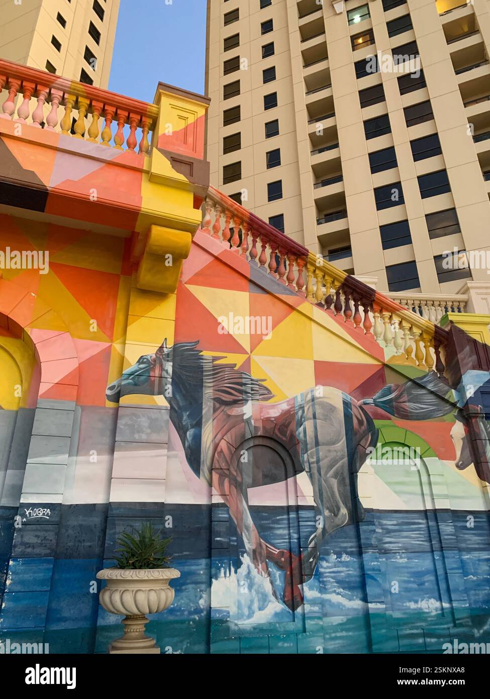 Large mural of running horse on Dubai Marina building Stock Photo - Alamy
