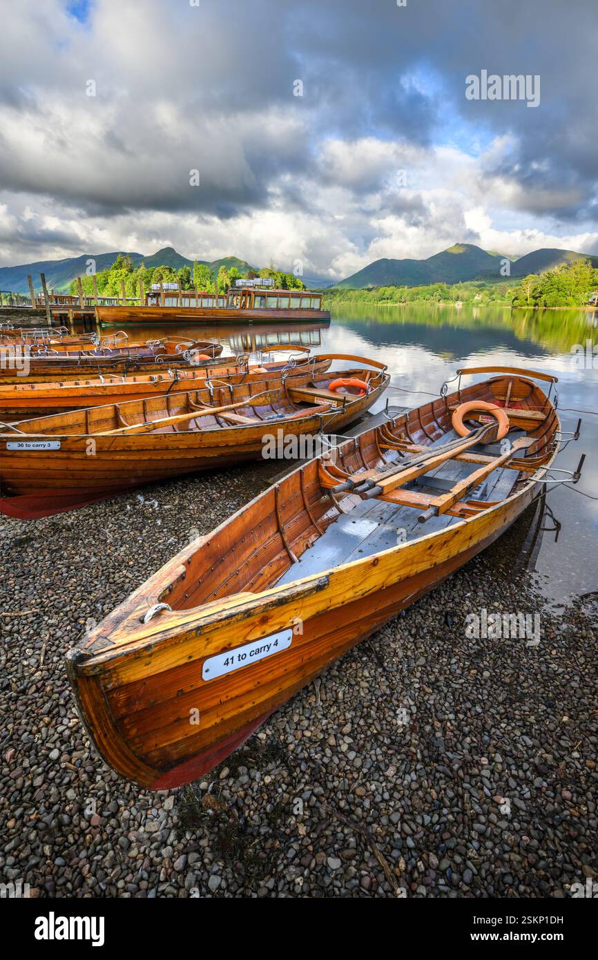 Wooden rowing boats on shoreline of Derwentwater in The Lake District ...