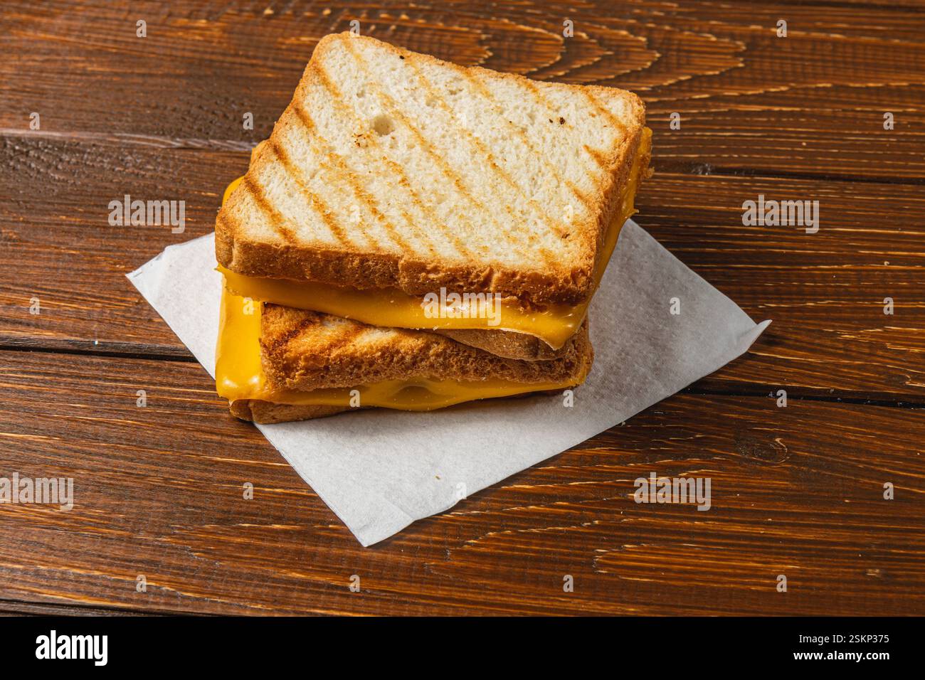 A perfectly toasted grilled cheese sandwich with melted cheese oozing ...