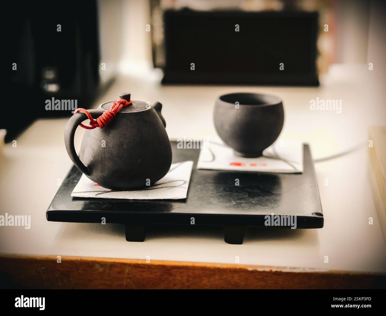 Close-up of a traditional Asian teapot and teacup on a table for a ...