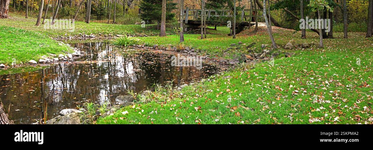 Stream running through a grassy terrain, curving around a bend and ...