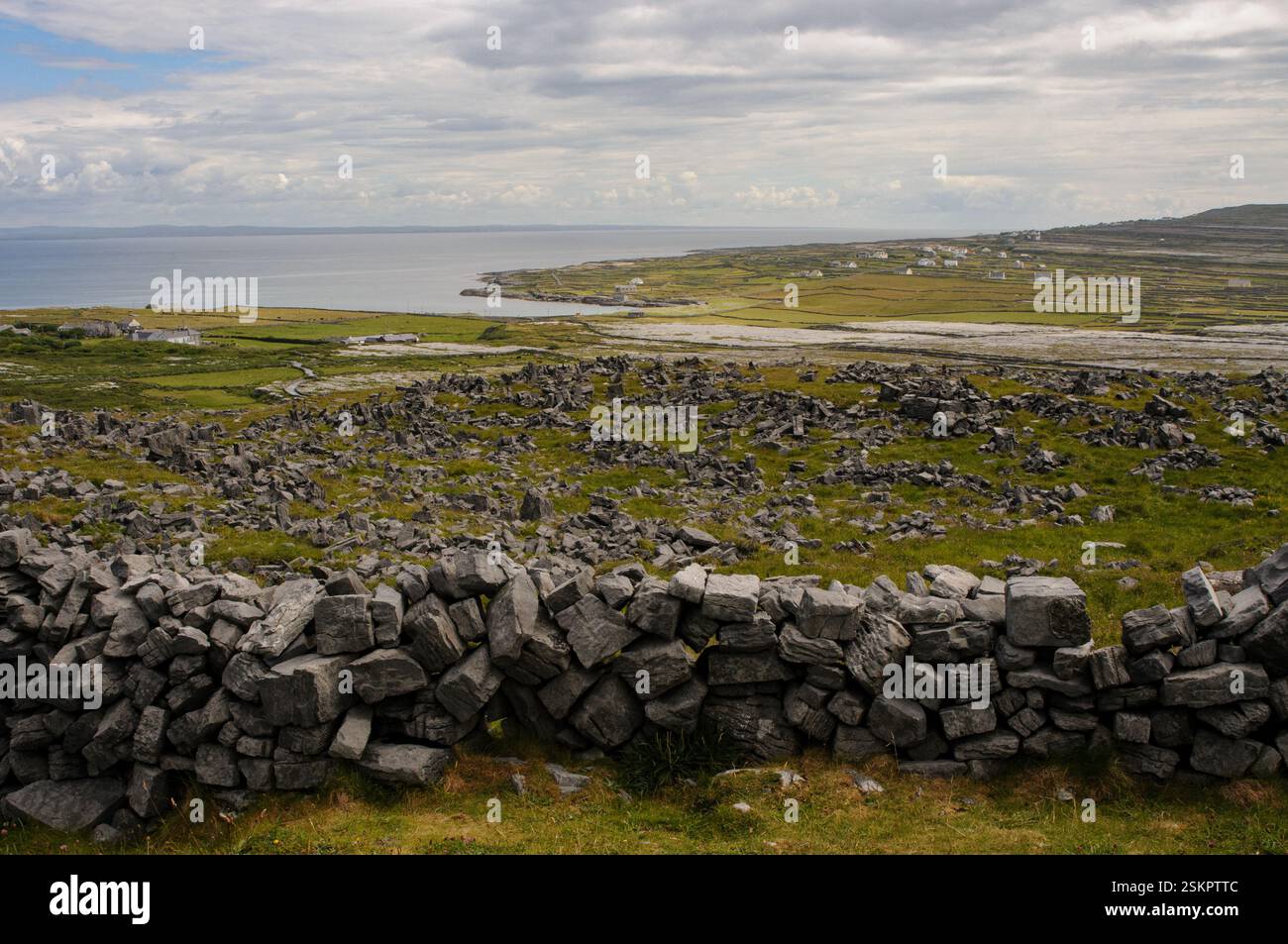 Stone lace wall frames the barren, seaside landscape of Inishmore, one ...