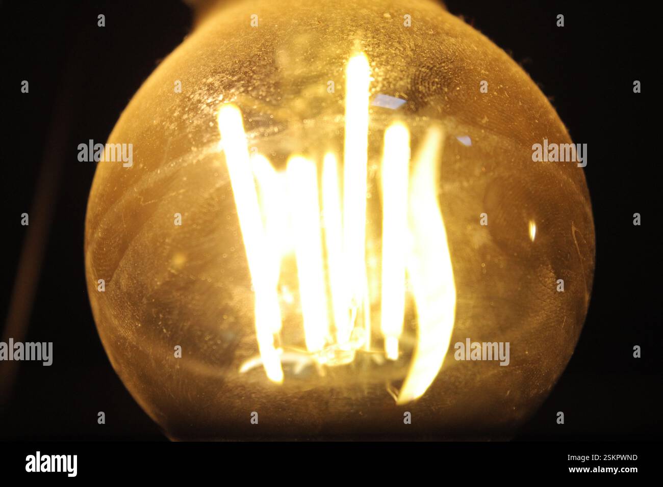 Close-up in a in a dusty edison yellow light bulb Stock Photo - Alamy