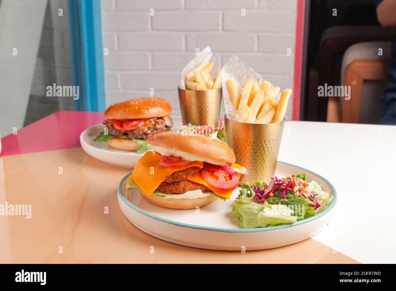 Gourmet beef and fried chicken burgers served with hand cut fries on a ...