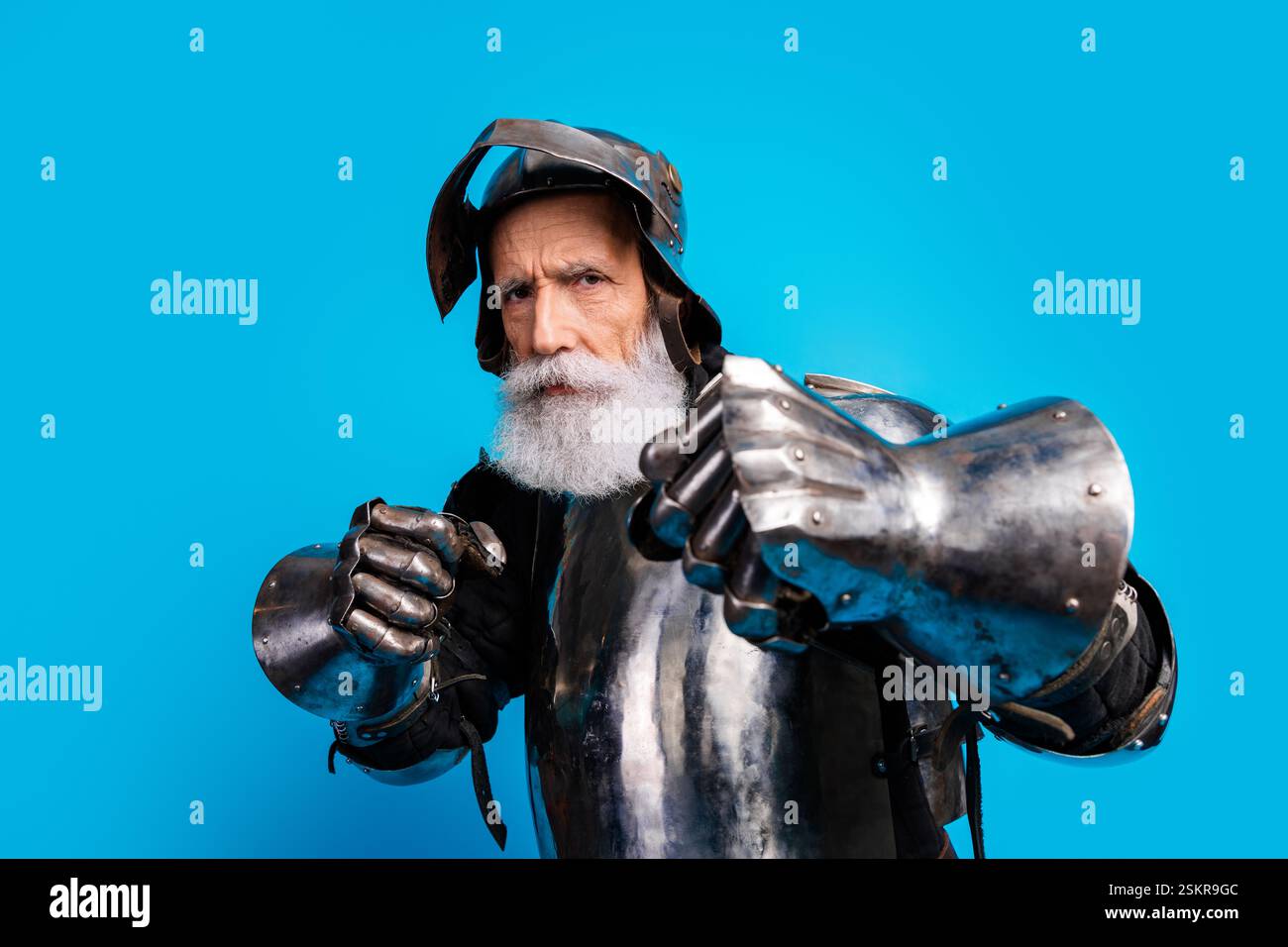 Portrait of a mature knight in medieval armor in a heroic pose with a ...