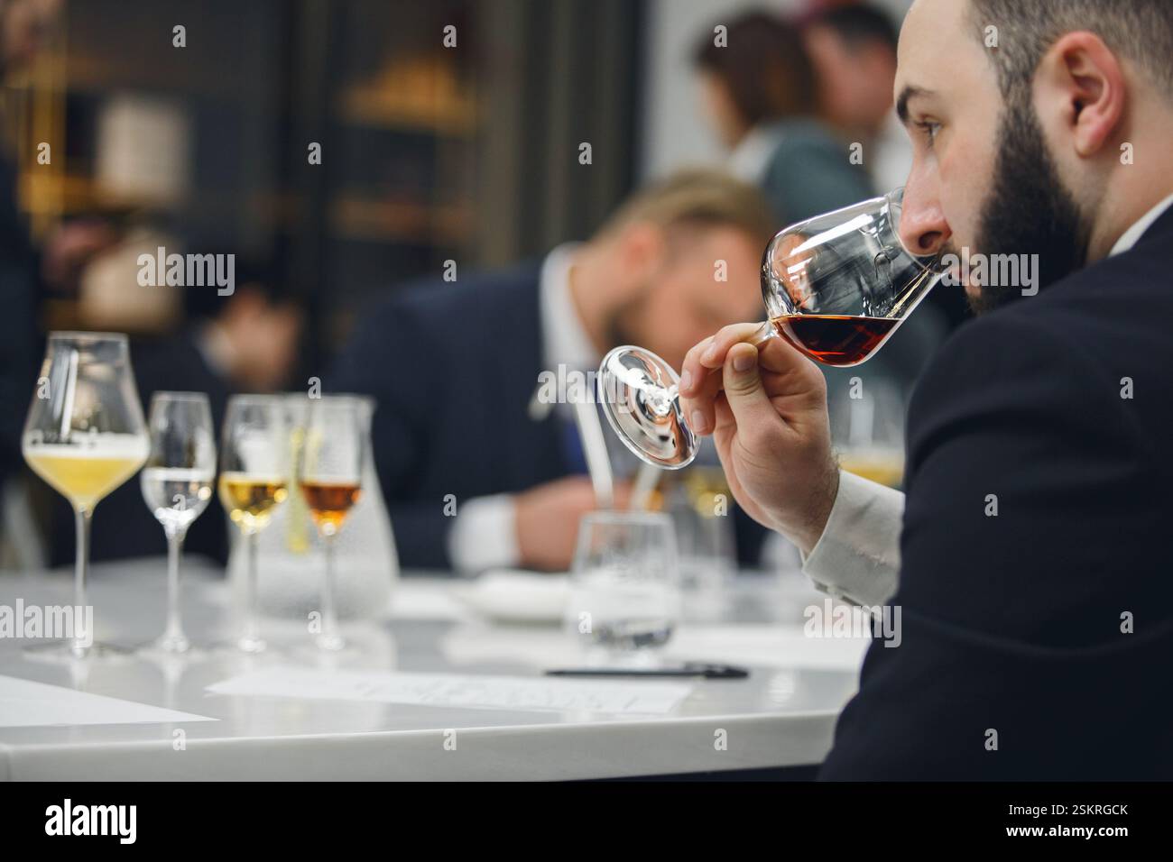 Professional sommelier sniffing various alcoholic drink during blind ...