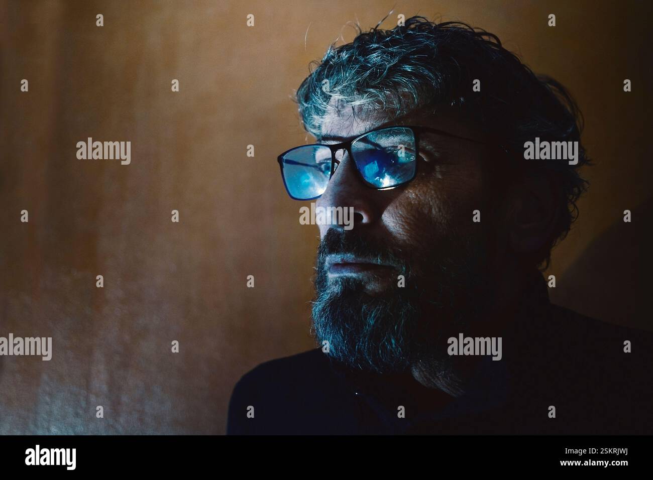 Expressive portrait of a middle-aged man, wearing glasses, with a ...