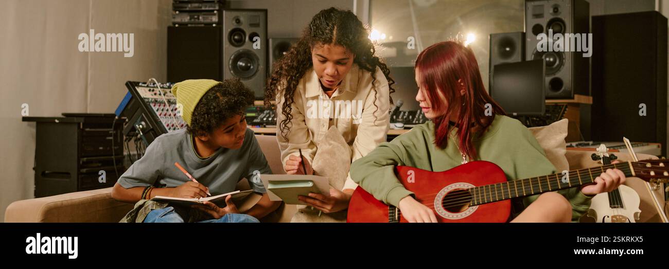 Website banner with biracial teen band reading lyrics of new song at ...