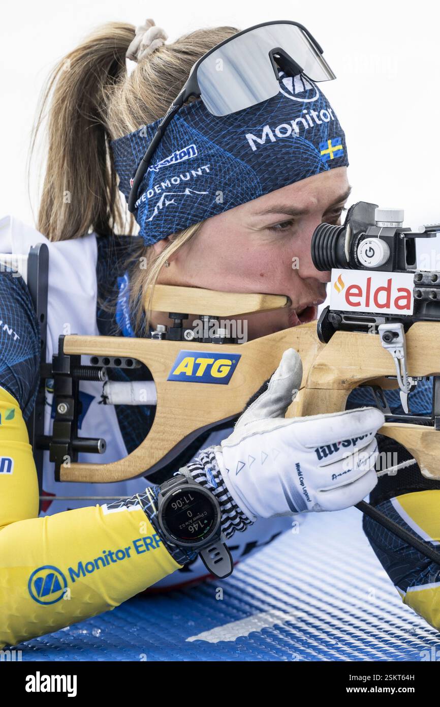 Anna Magnusson of Sweden shoots her rifle during the mixed relay race ...