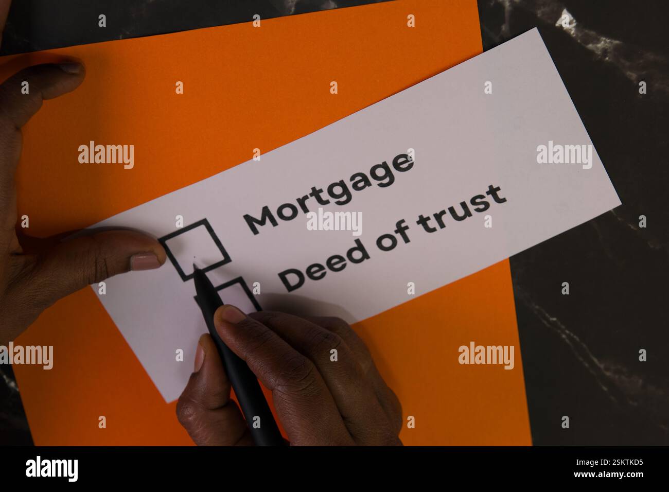 Person marking choices for mortgage and deed of trust paperwork on a ...