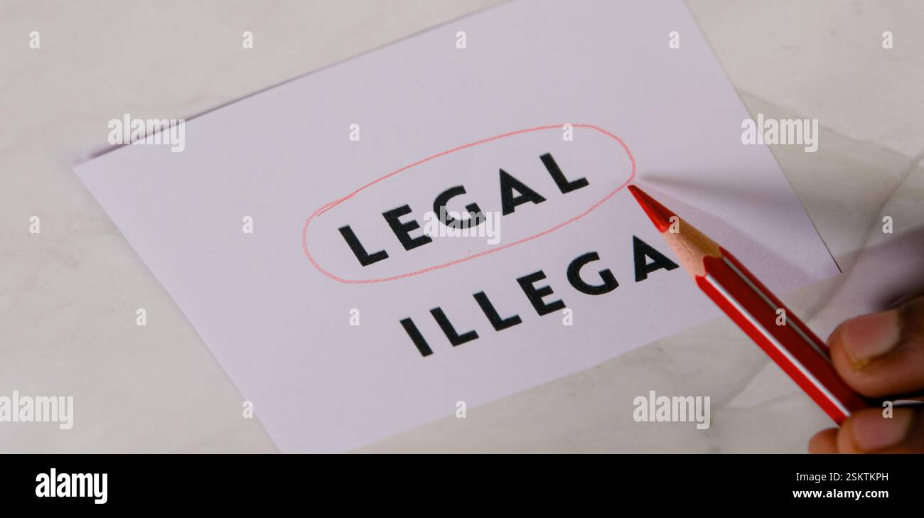 A hand marks legal and illegal in red pencil on paper, showing the ...