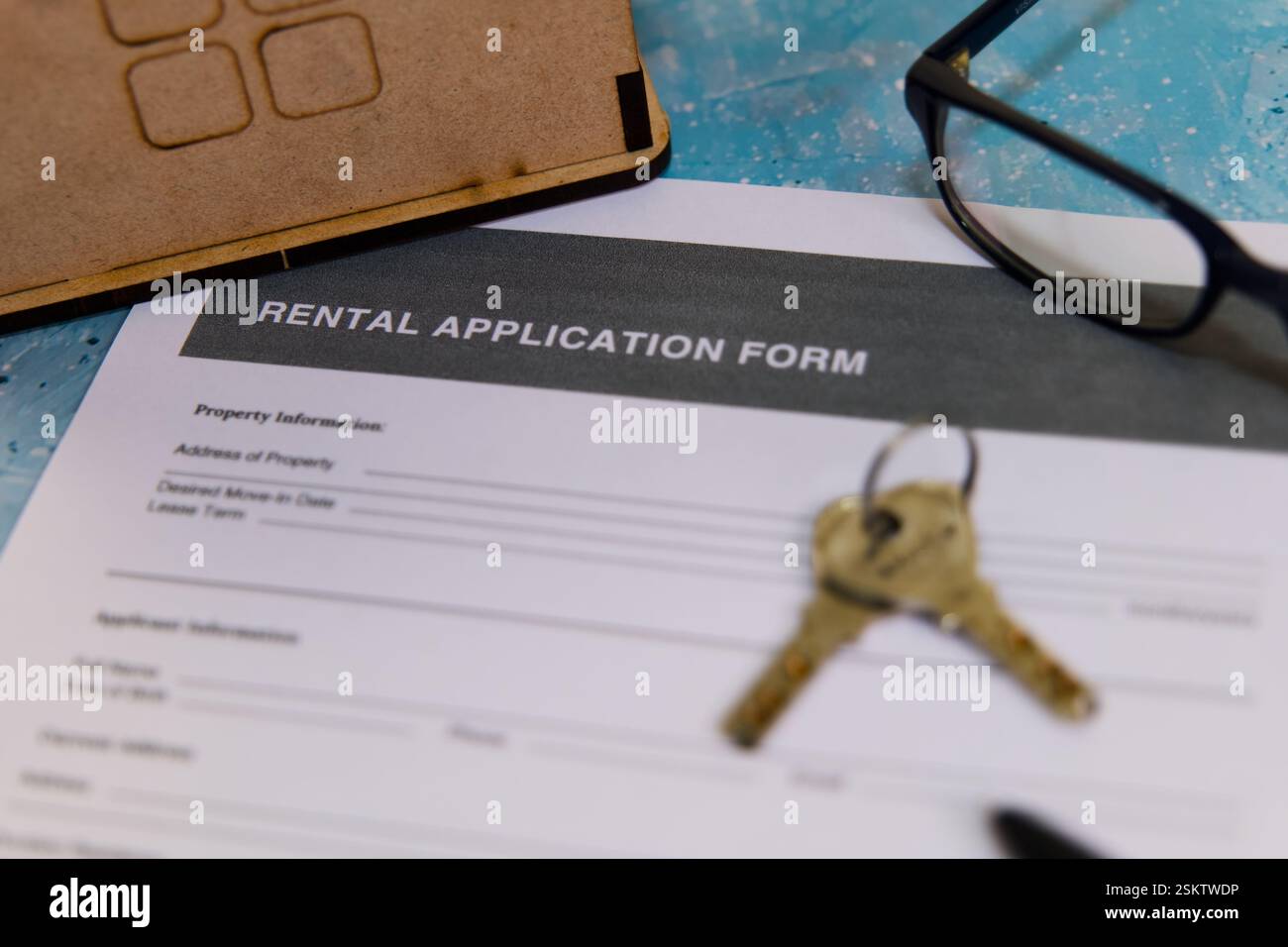 A close-up view of a rental application form with keys and reading ...