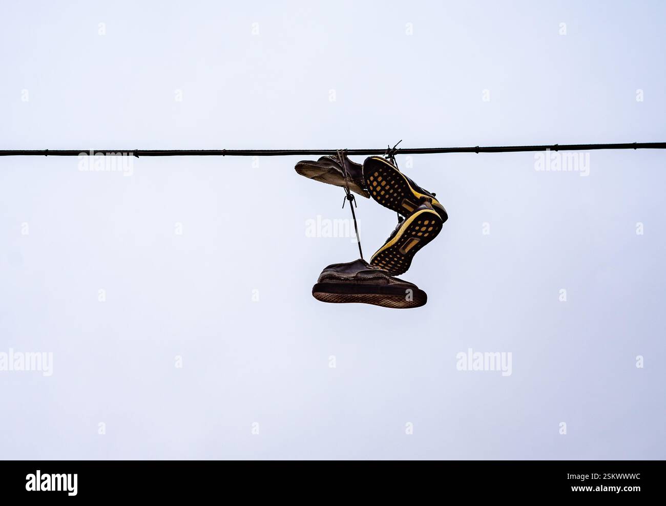 old shoes hanging on a rope Stock Photo - Alamy