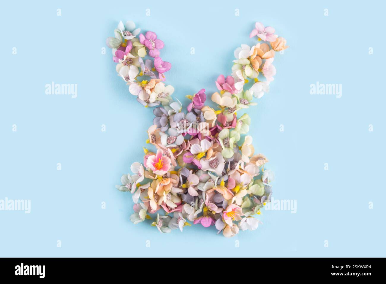 Easter spring holiday background with bunny rabbit made with flowers, creative diy Easter ...