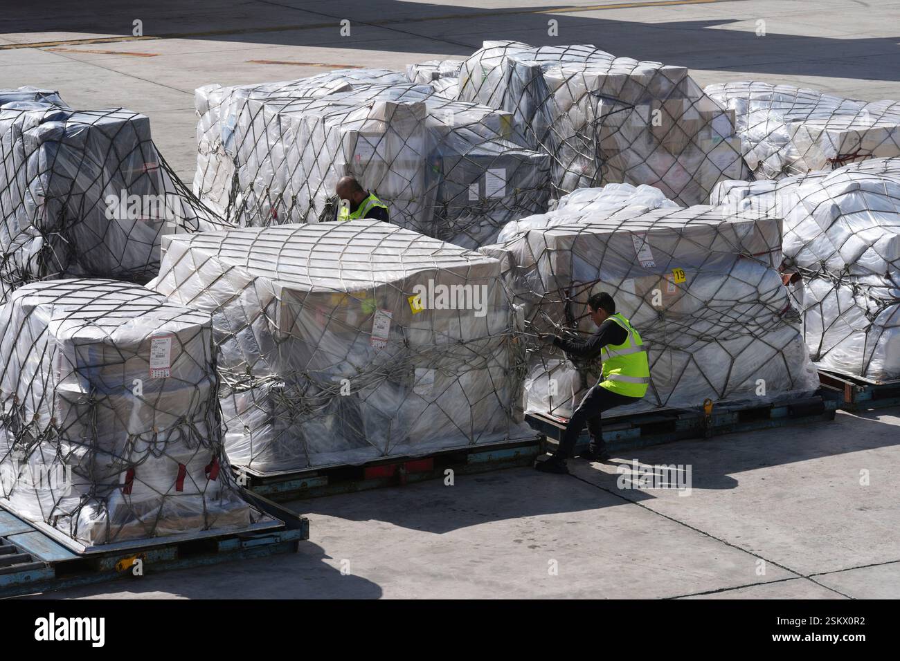 An air cargo employee checks pallets of imported items from South ...