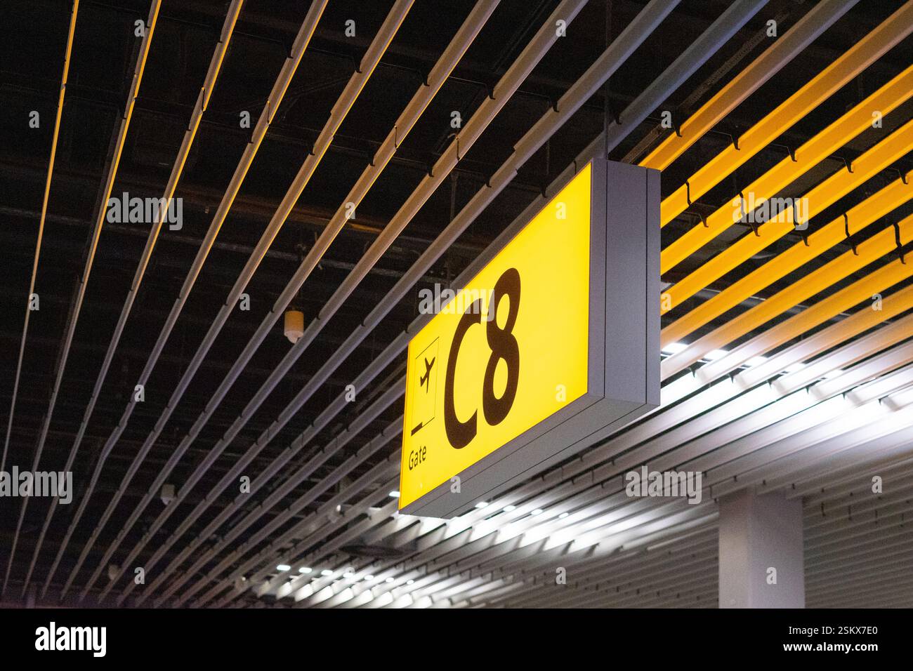 Illuminated gate c8 sign displaying flight details in a modern airport ...