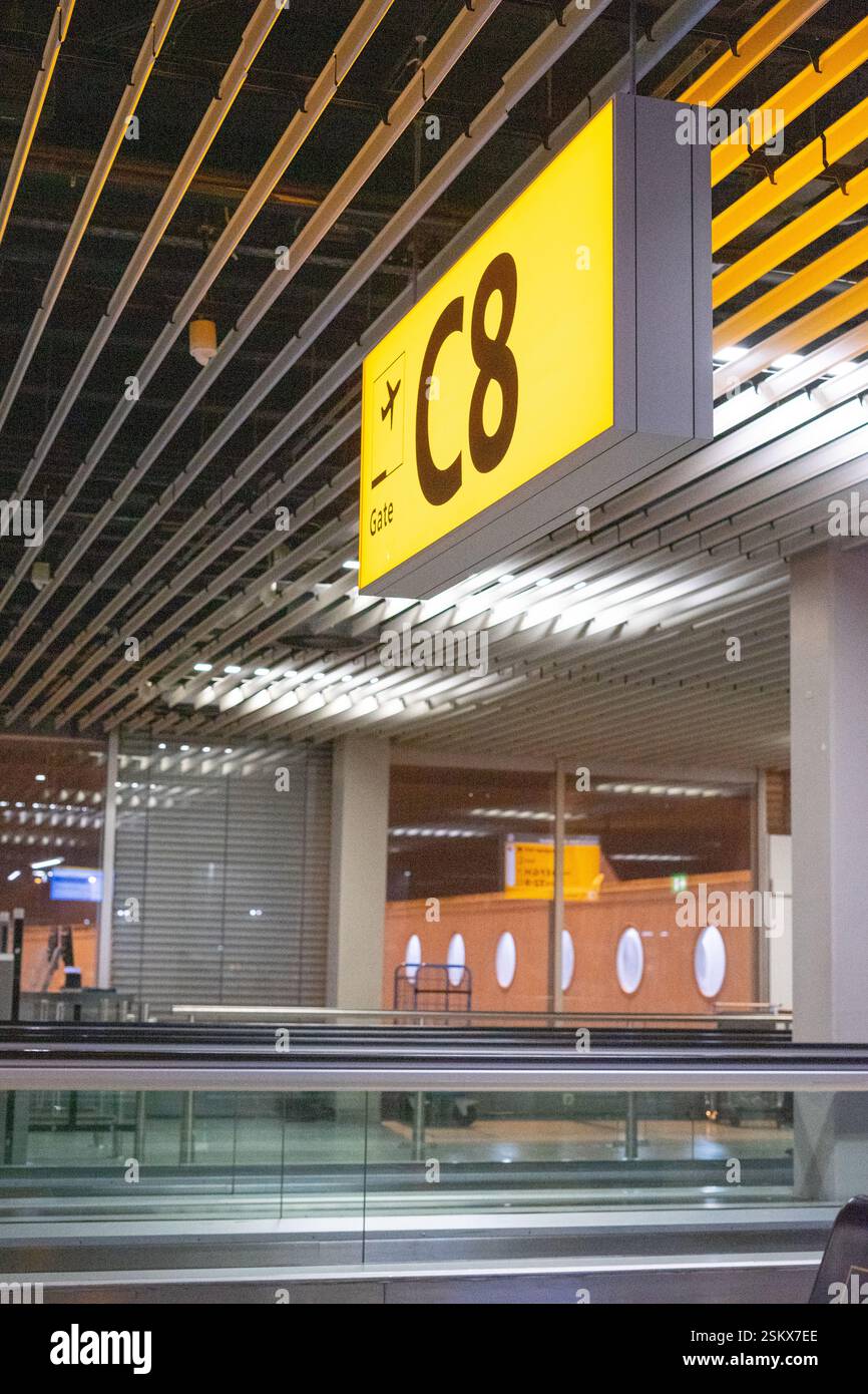 Illuminated gate c8 sign displaying flight details and guiding ...