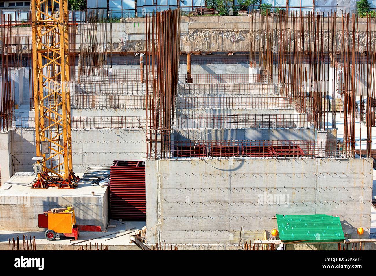 Construction site bustling with activity under a bright sun in an urban ...
