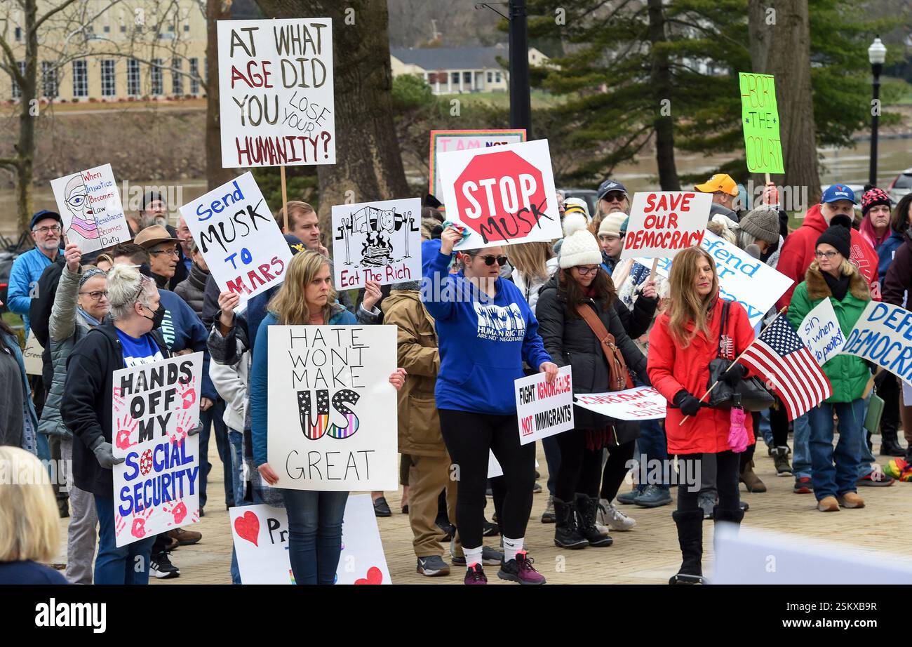FILE - Protestors hold signs while listening to speakers during during ...