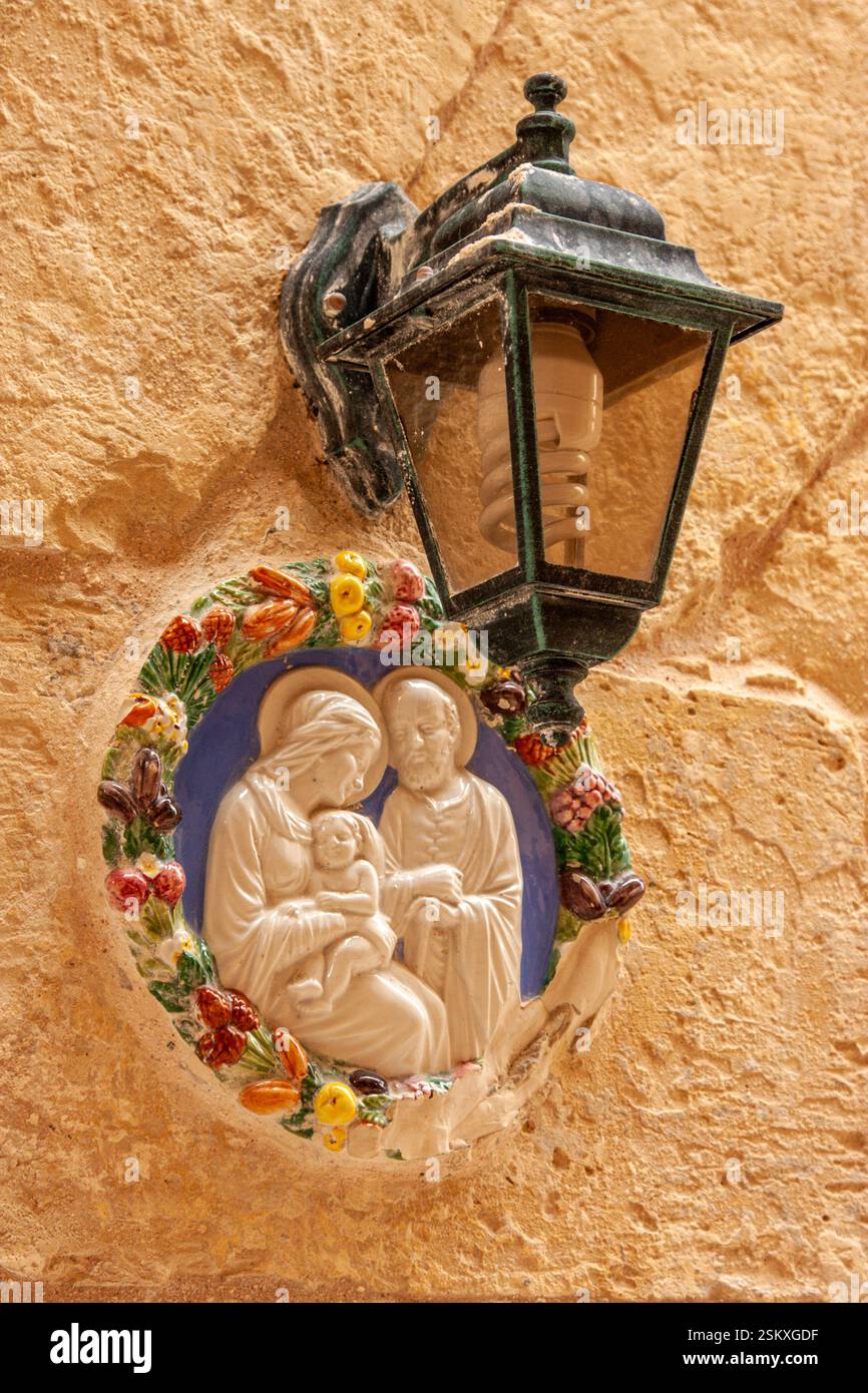 Exterior architectural detail featuring lantern with painted carving of ...