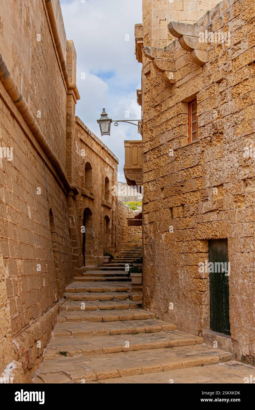 Beautiful stone walls frame shallow stone steps to form an alleyway ...