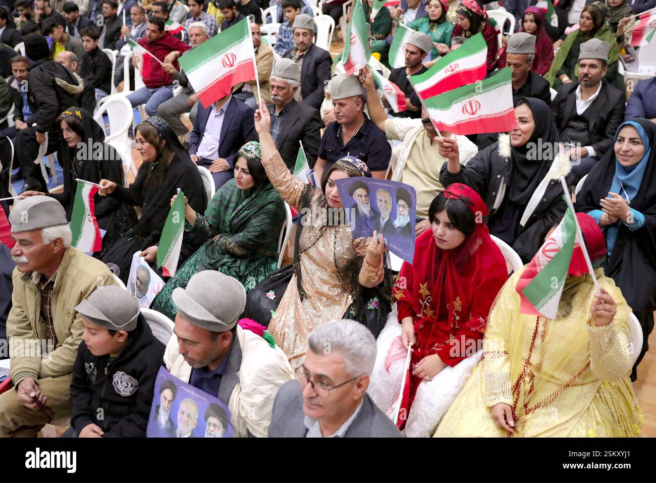 Bushehr, Iran. 12th Feb, 2025. People wave the national flag at a ...