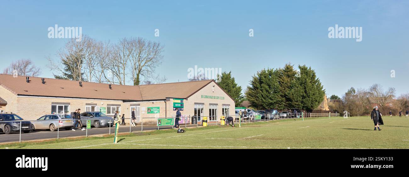 Players and spectators outside the club house of Bugbrooke rugby union ...