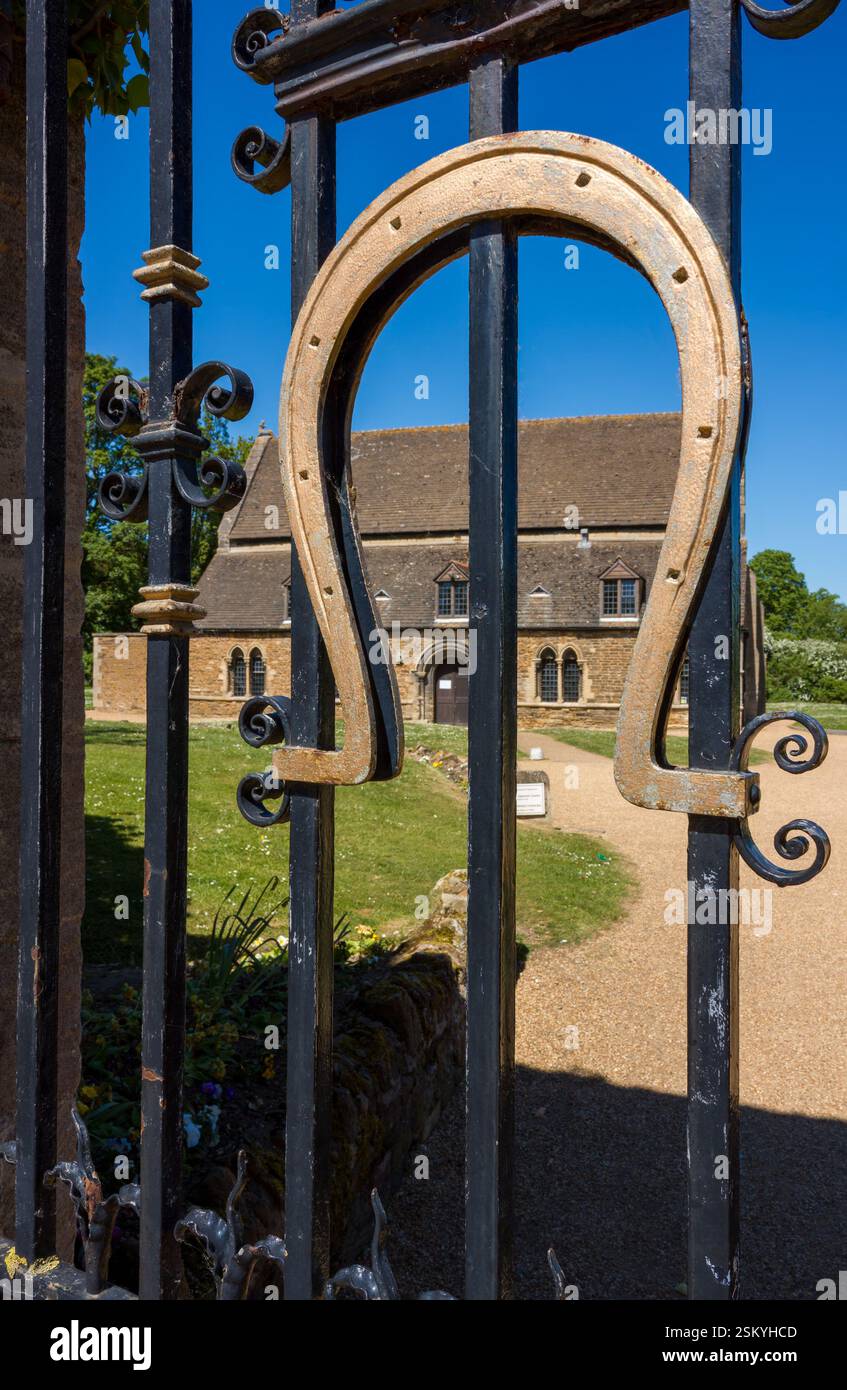 Golden horseshoe on the black wrought iron gates of Oakham Castle, with ...