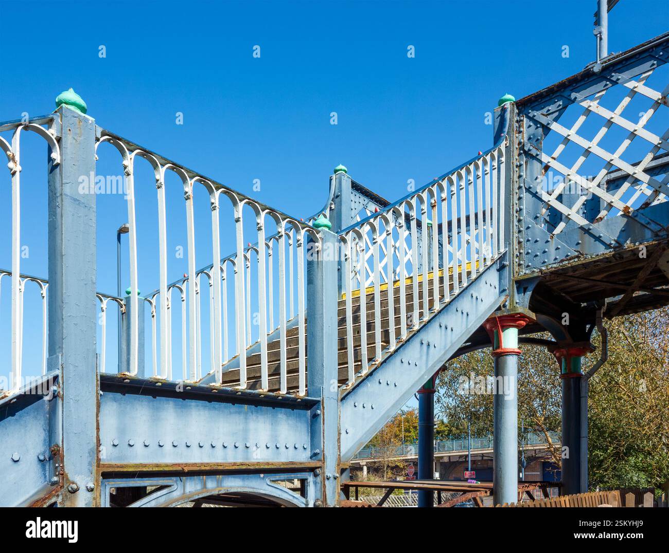 Old painted cast and wrought iron passenger footbridge at Melton ...