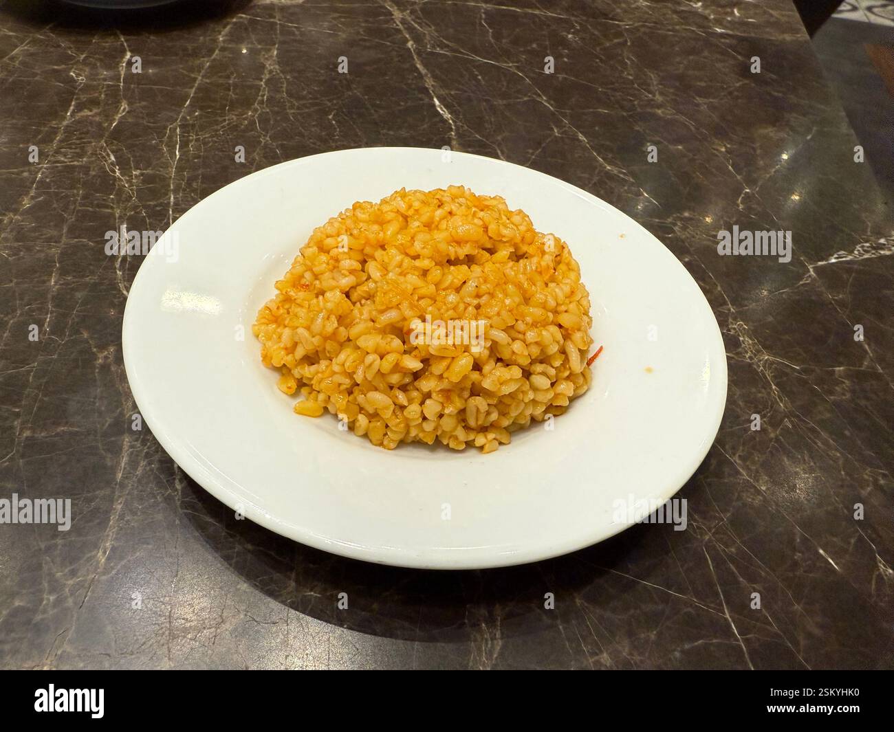 Bulghur Turkish traditional food tomato bulgur pilaf on black stone ...