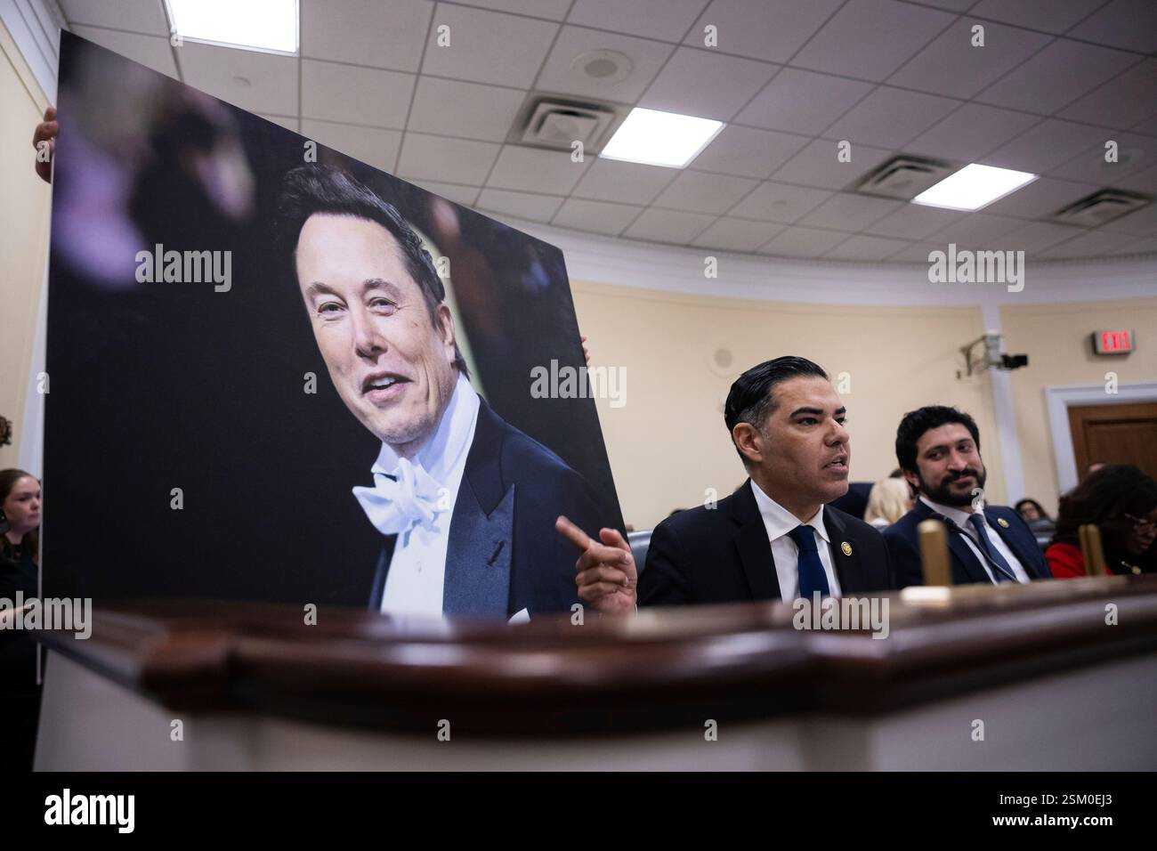 Rep. Robert Garcia (D-Calif.) displays a picture of Elon Musk while Rep ...