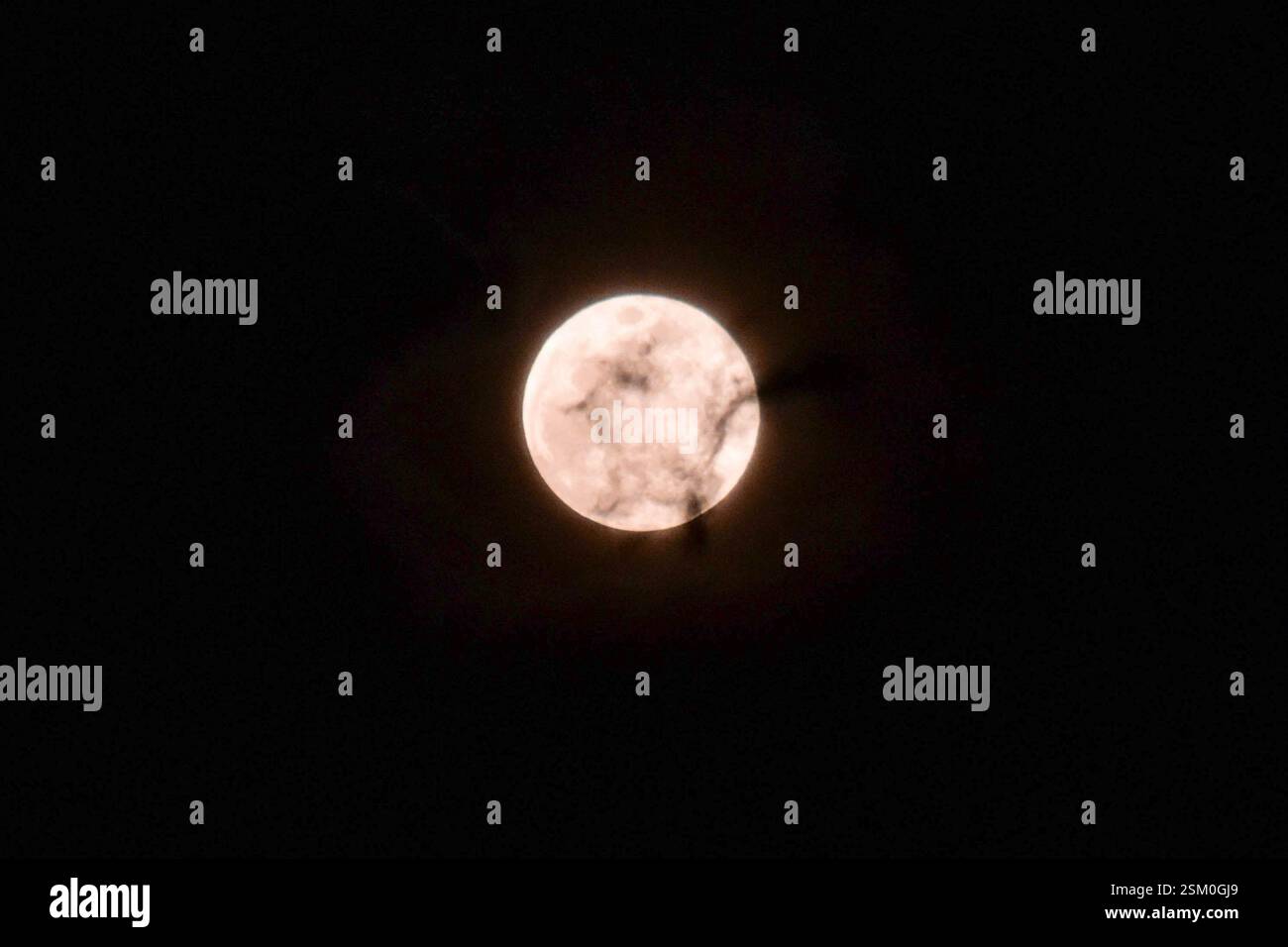Srinagar, India. 12th Feb, 2025. The full Snow Moon rises between the ...