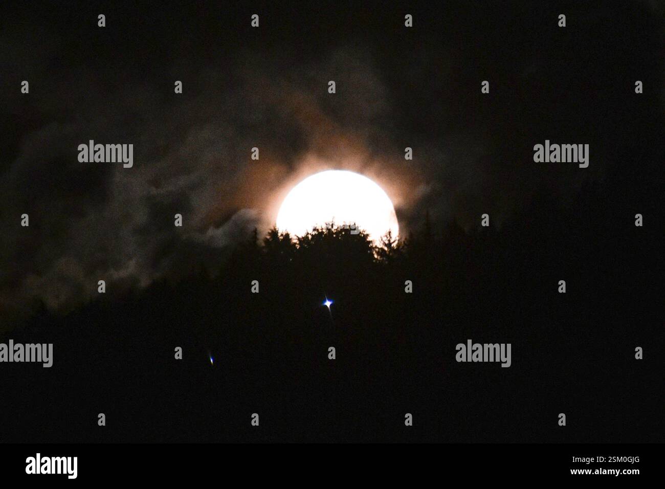 Srinagar, India. 12th Feb, 2025. The full Snow Moon rises behind the ...