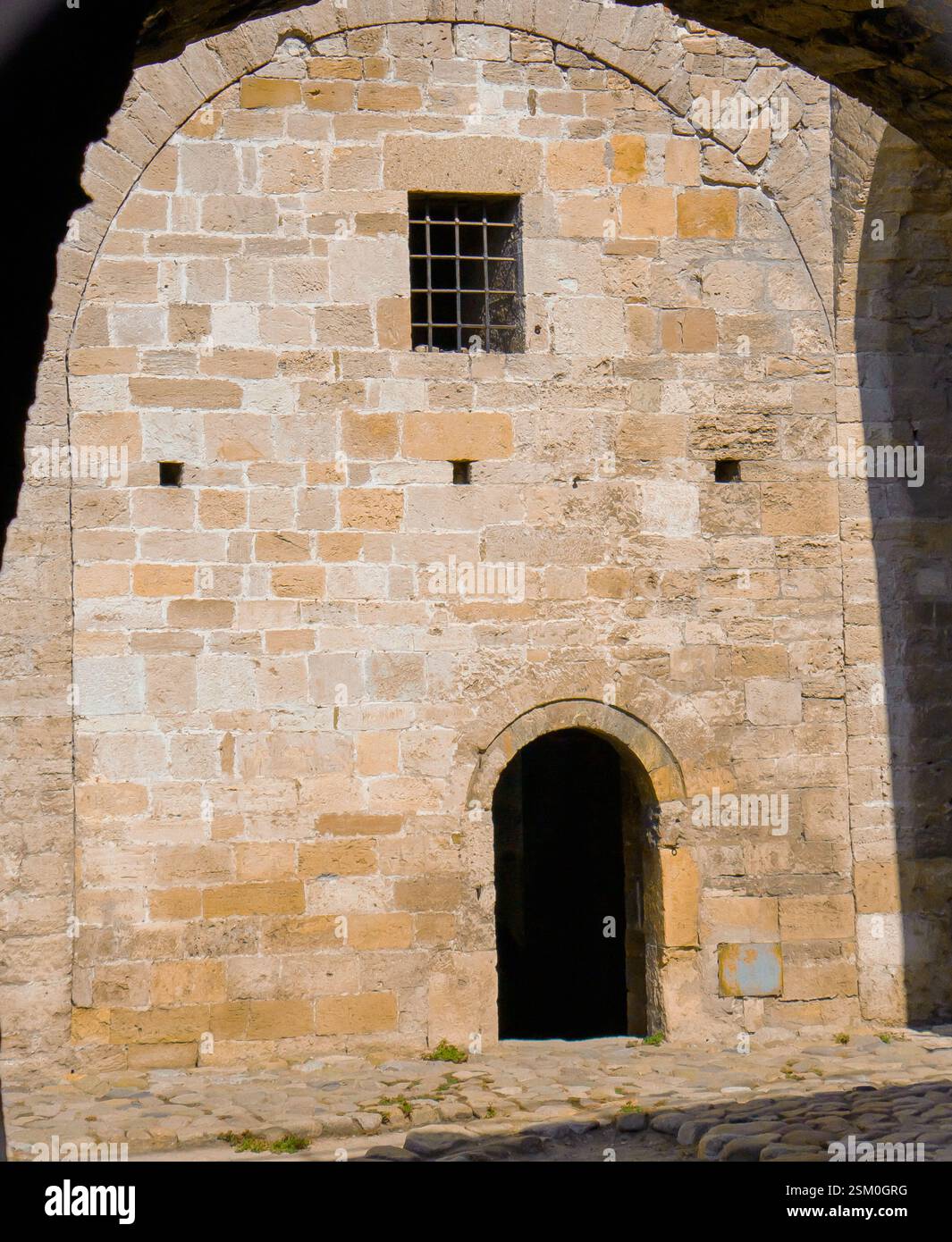 Weathered stone blocks form the entrance of an ancient building ...
