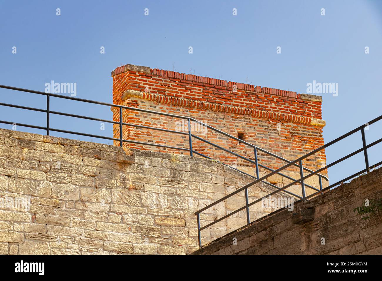 Old brick construction features a distinctive red brick top, surrounded ...