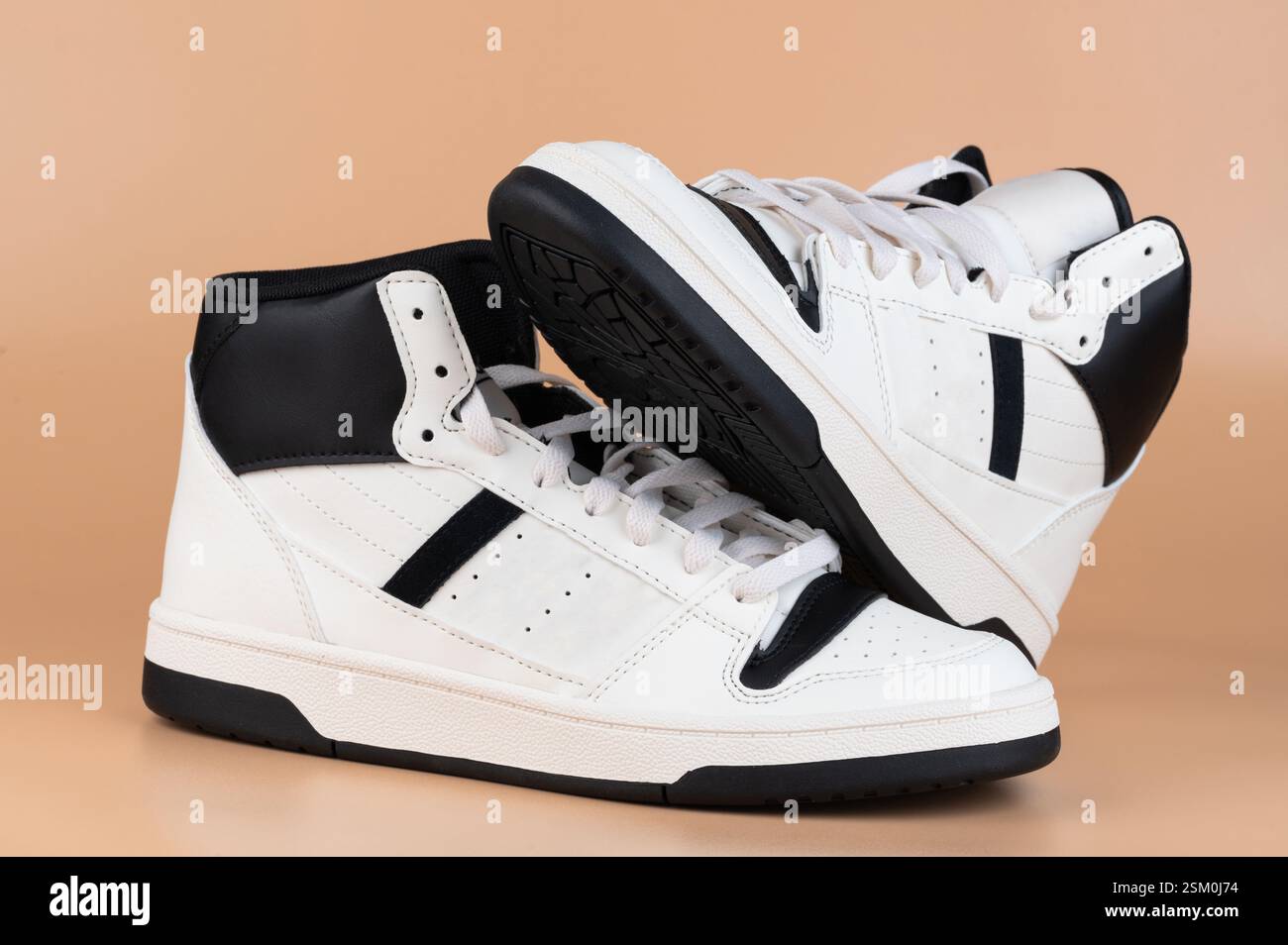 Tall boot sport leather shoes side view on beige color studio ...