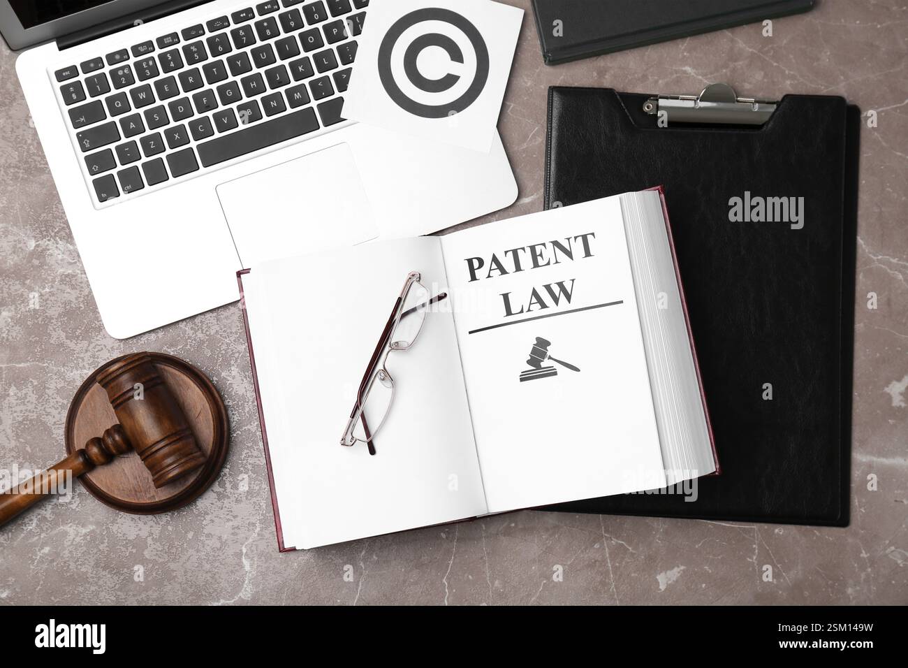 License. Patent law book, laptop, paper with copyright symbol and judge ...