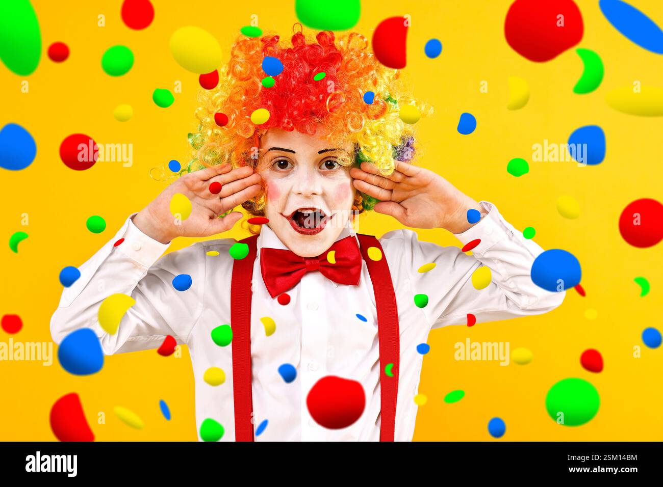 Cute boy dressed like clown under falling confetti on orange background ...