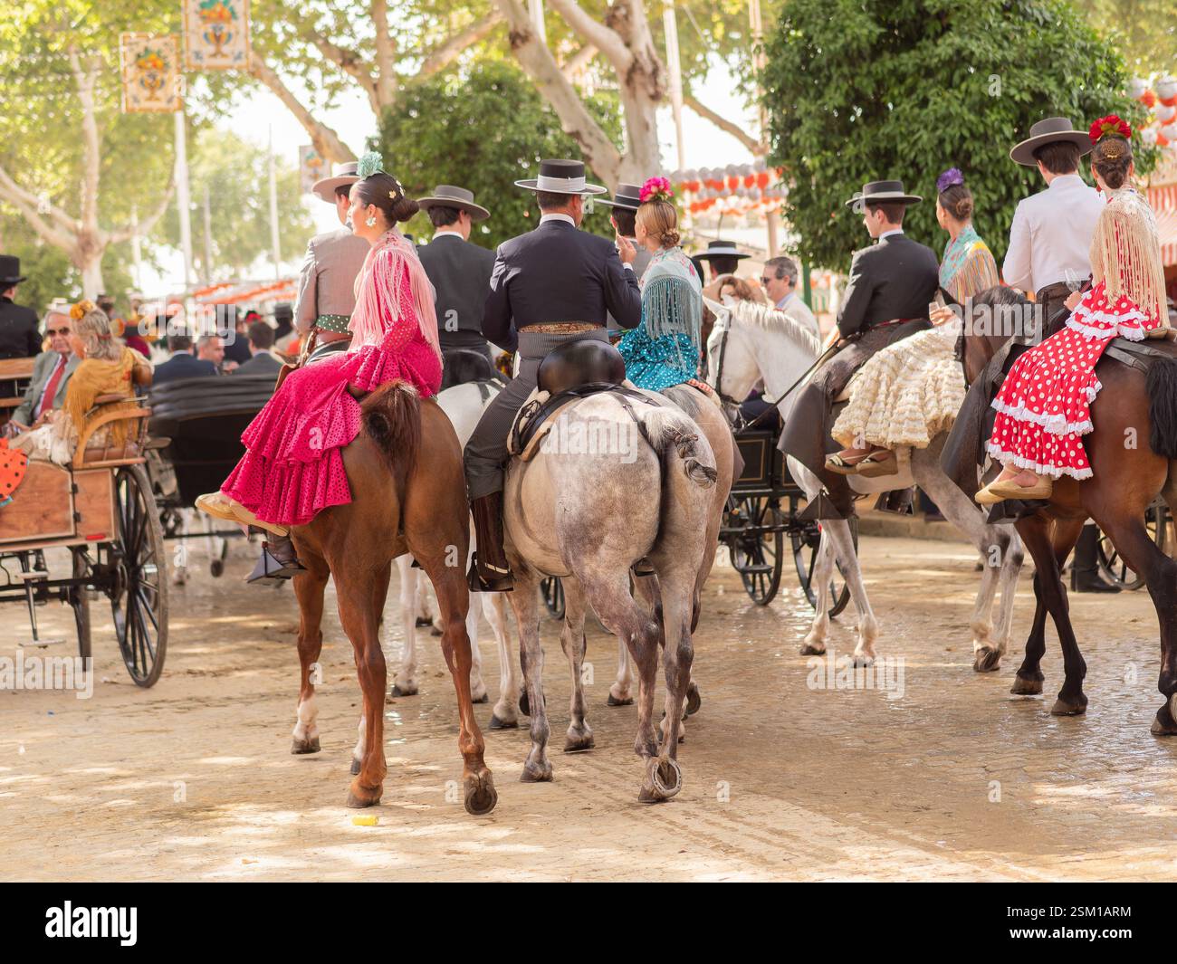Group of Spanish riders in traditional attire on horseback at an ...
