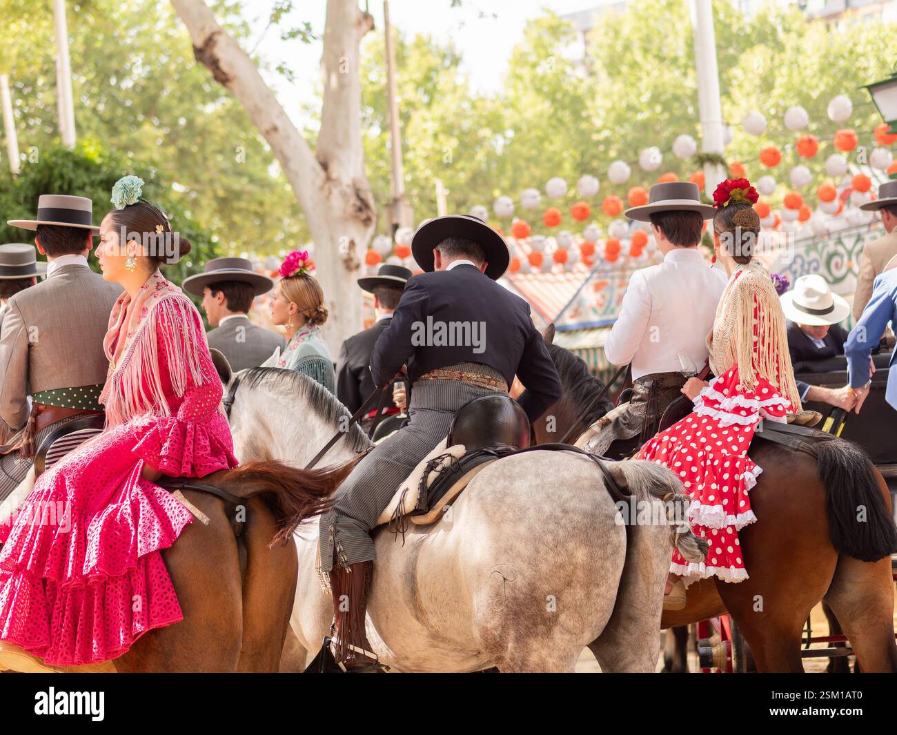 Group of Spanish riders in traditional attire on horseback at an ...