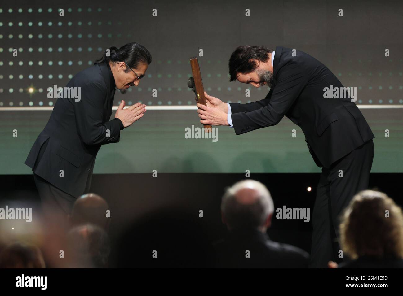 Beverly Hills, USA. 11th Feb, 2025. Keanu Reeves, right, presents the ...