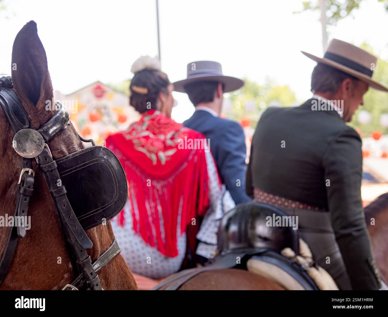 Group of Spanish riders in traditional attire on horseback at an ...