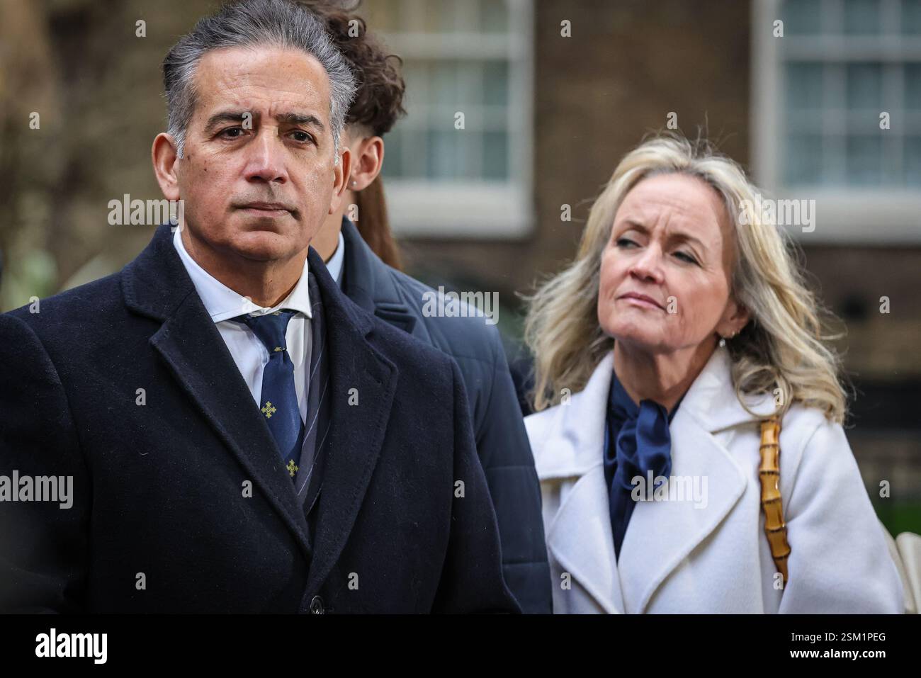 London, UK. 12th Feb 2025. Dr Sanjoy Kumar speaks to press (middle), his wife Dr Sinead O'Malley ...